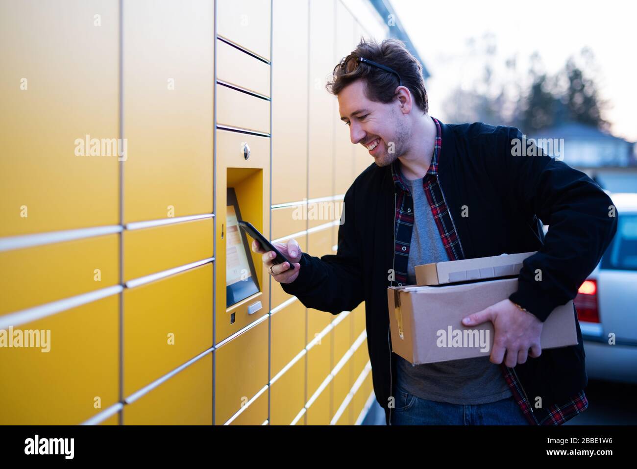 A man brings packages to a packing station or picks them up Stock Photo ...