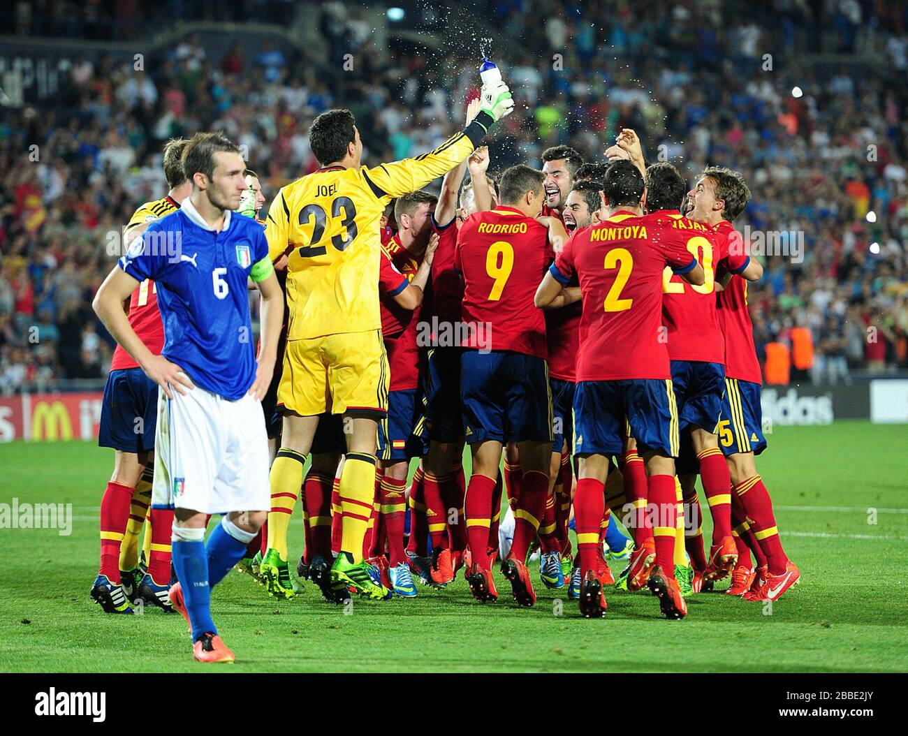 Italy's Luca Caldirola dejected as Spain celebrate winning the UEFA ...