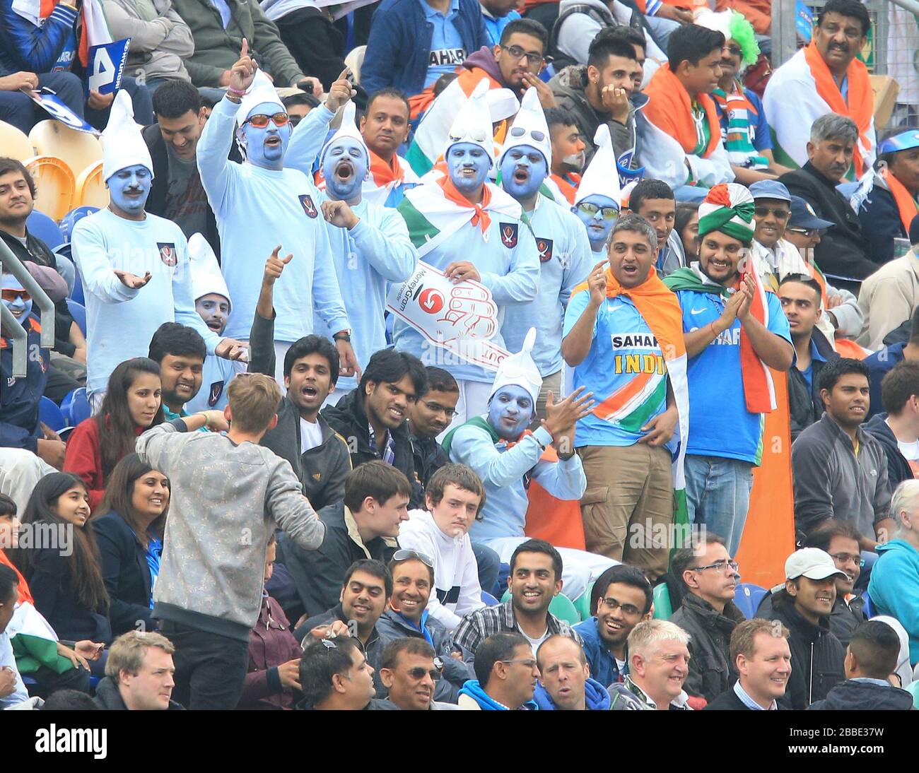 Indian fans dressed as smurfs celebrate victory Stock Photo - Alamy