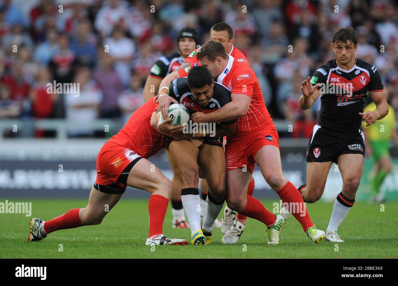 St. Helens' Willie Manu is tackled by Salford City Reds' Danny Williams ...