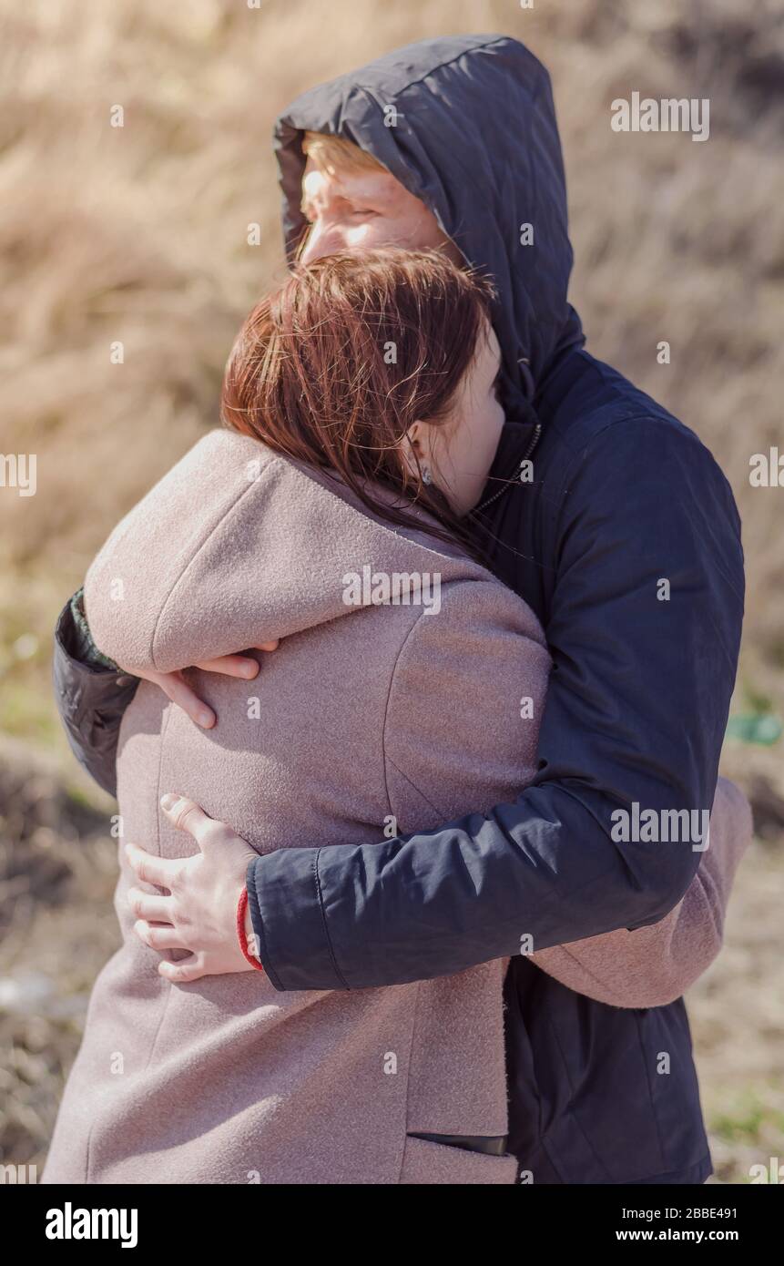 A young guy hugs a girl. The process of reconciliation of a quarreling ...