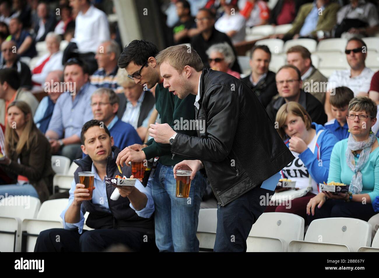 Spectators grab a drink inside the Kia Oval before the match Stock ...