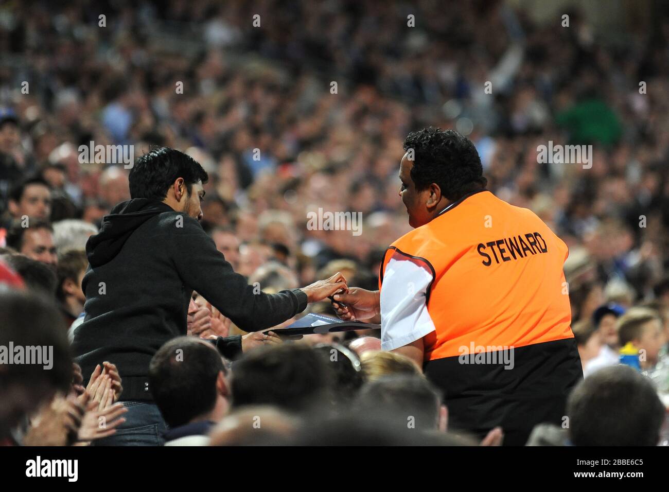 A steward signs a autograph for a fan Stock Photo - Alamy