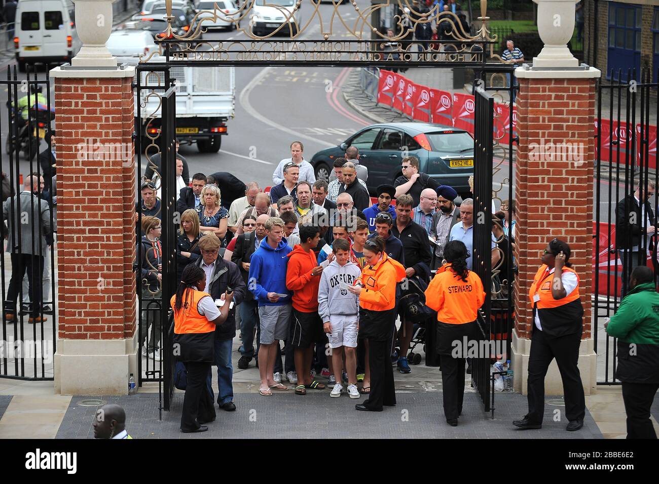 Stewards open the gates to let the crowd of spectators into the ground ...
