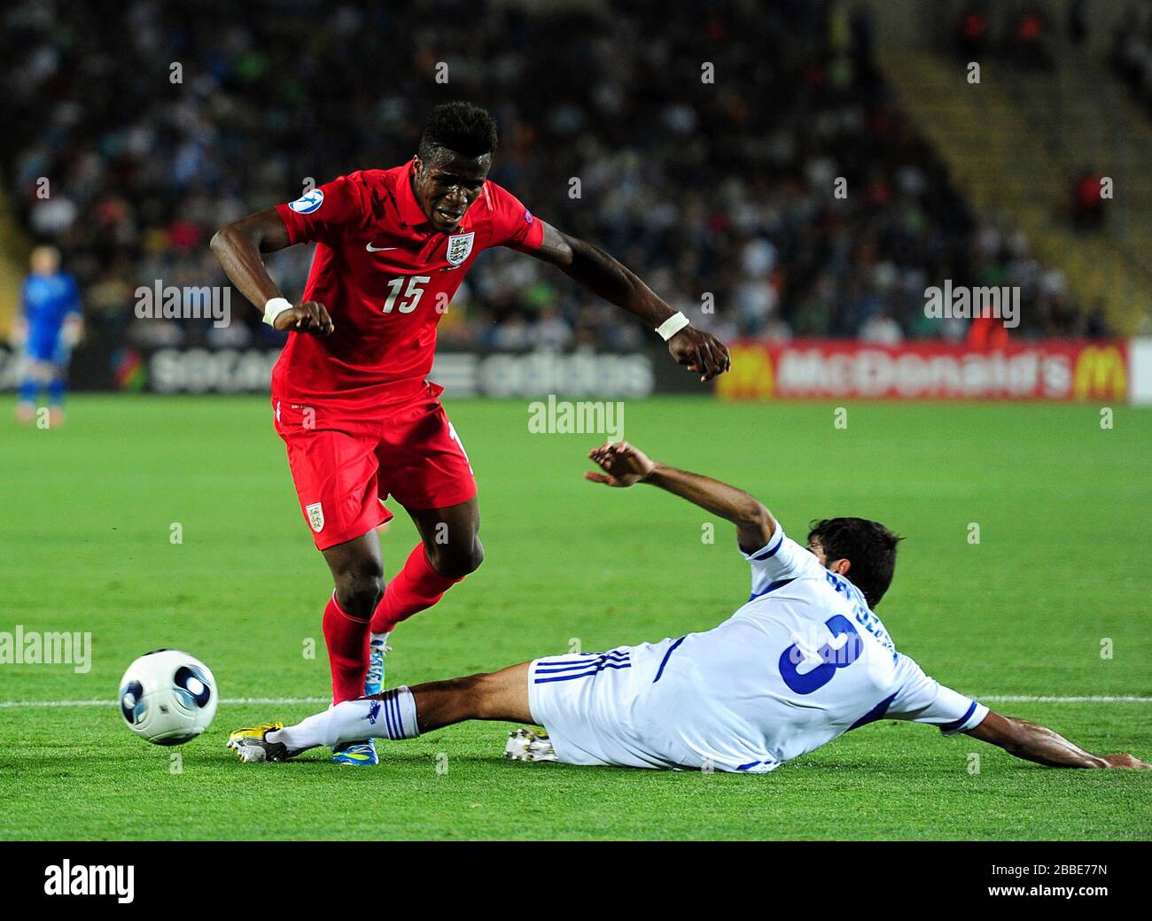 Israel's Ofir Davidadza (right) slides in on England's Wilfried Zaha ...