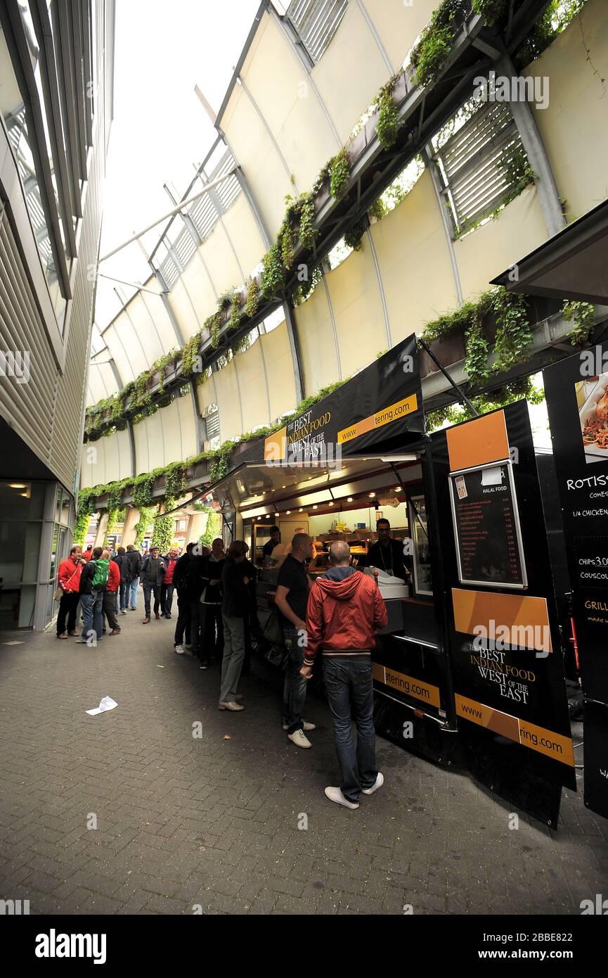 Fans queue up at the Best Indian Food West of the East stand Stock ...