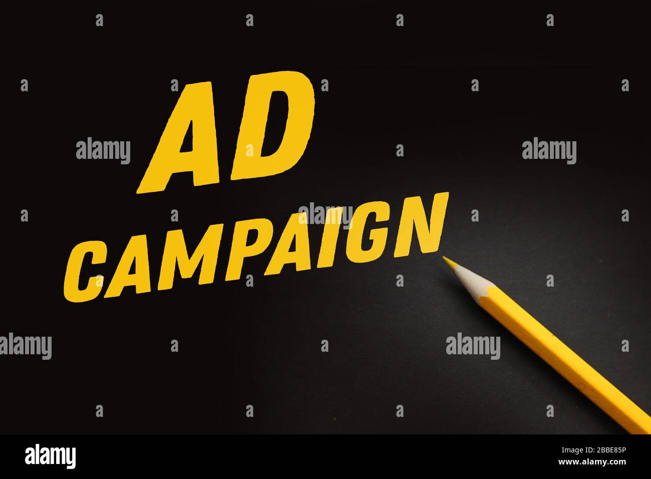 Pencil writing the word s Ad campaign. Advertising marketing concept ...