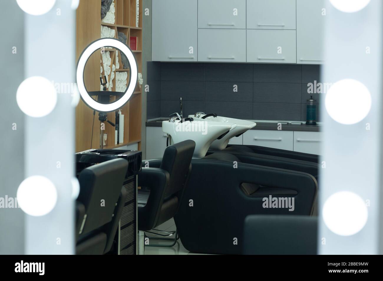 Reflection in mirror with illumination in barbershop Stock Photo - Alamy