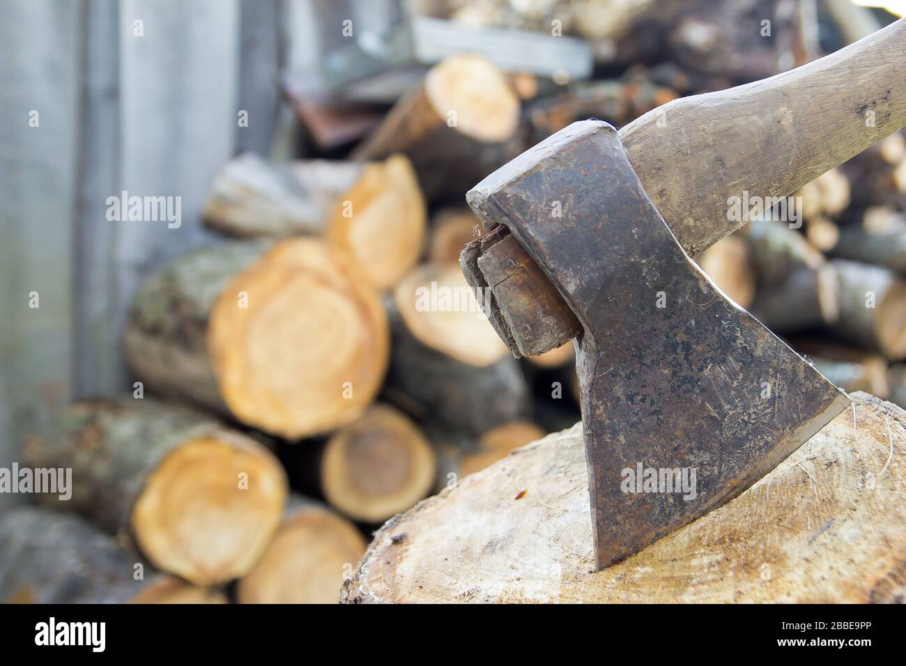 Cut logs fire wood and old axe Stock Photo - Alamy