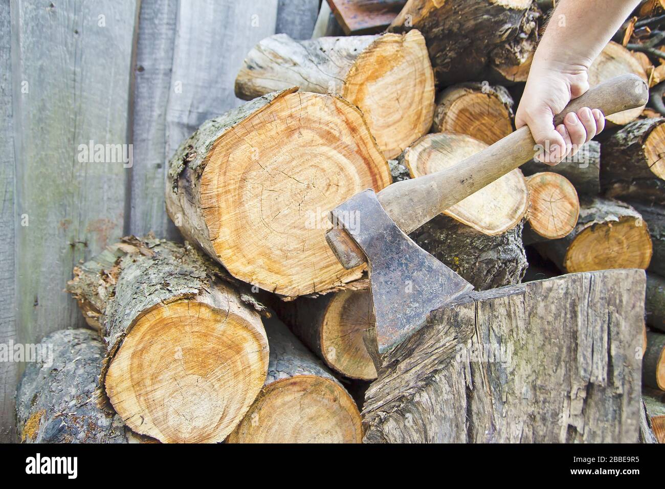 Cut logs fire wood and old axe Stock Photo - Alamy
