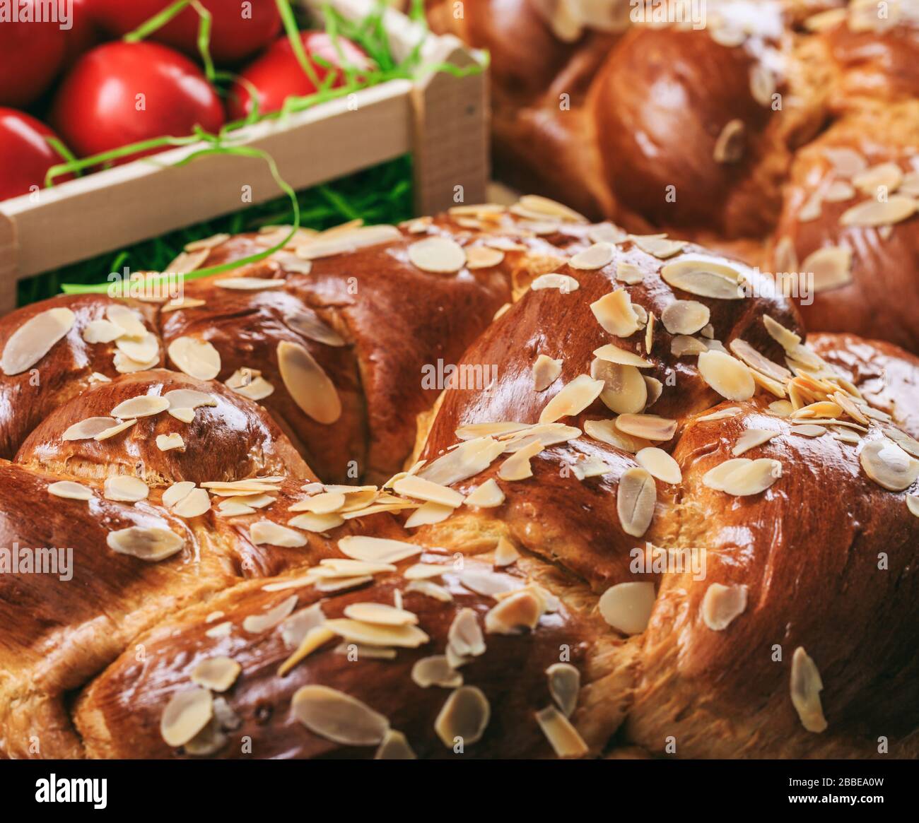 Easter traditional sweet bread, greek tsoureki and red eggs closeup ...