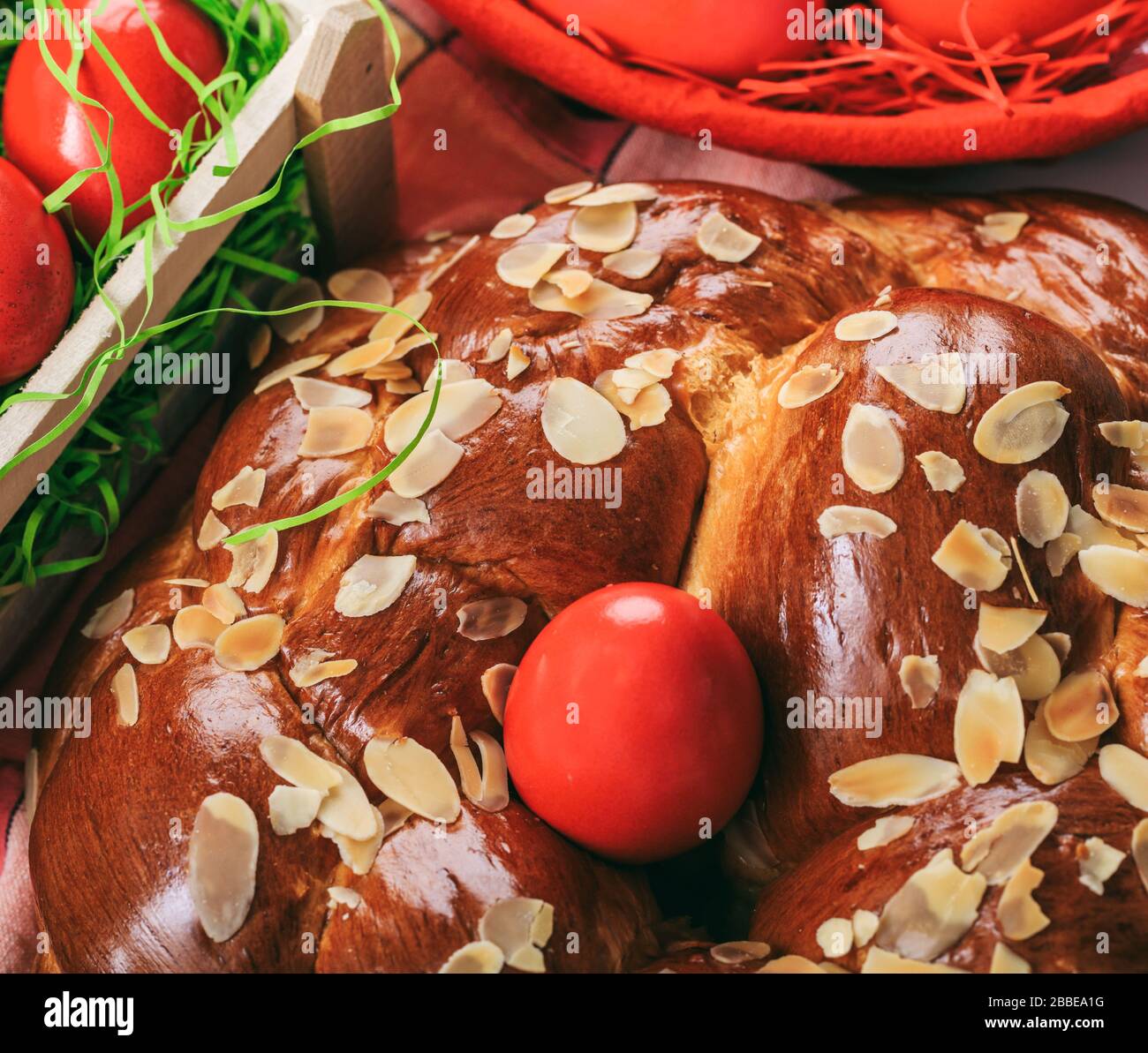 Easter traditional sweet bread, greek tsoureki and red eggs closeup ...