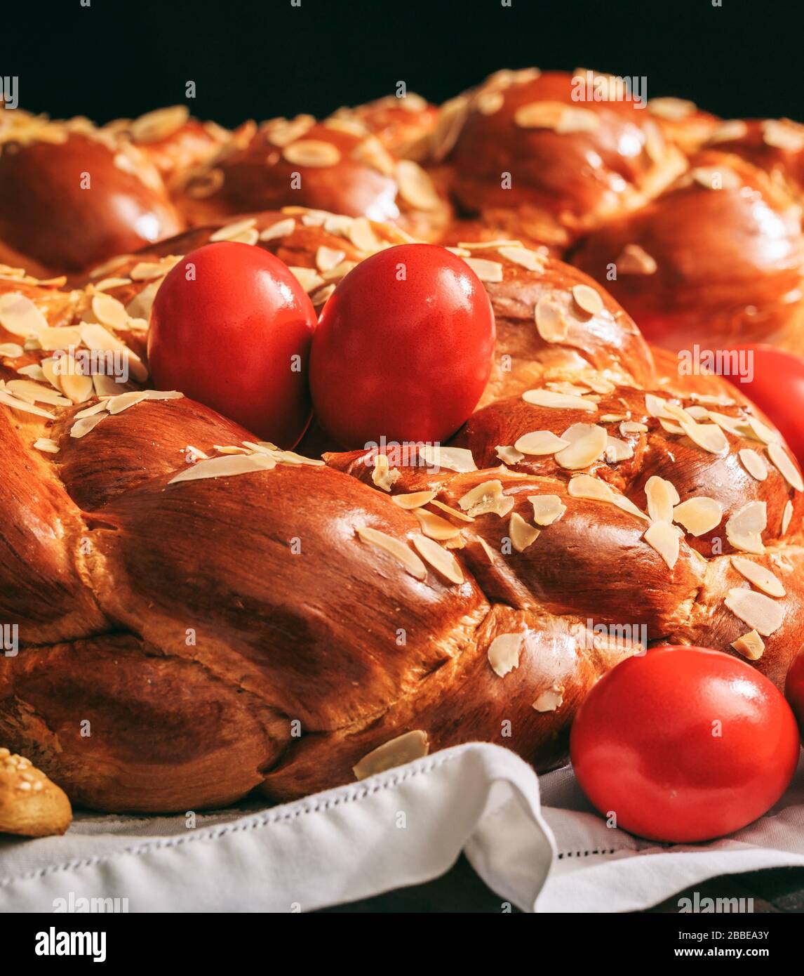 Easter traditional sweet bread, greek tsoureki and red eggs closeup ...