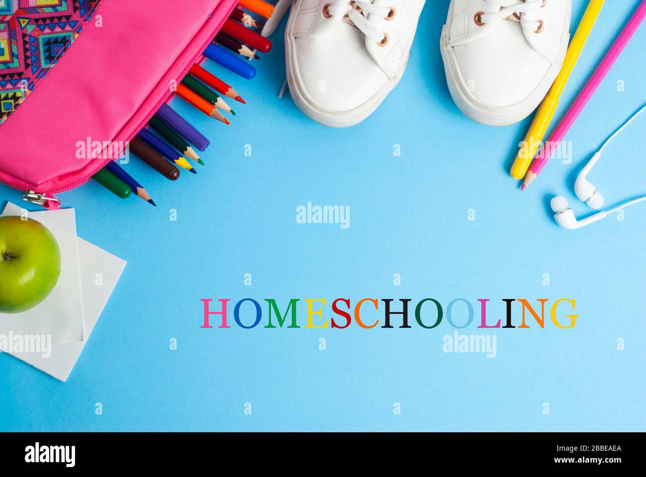 Homeschooling text over blue background with colorful pencils and sport ...