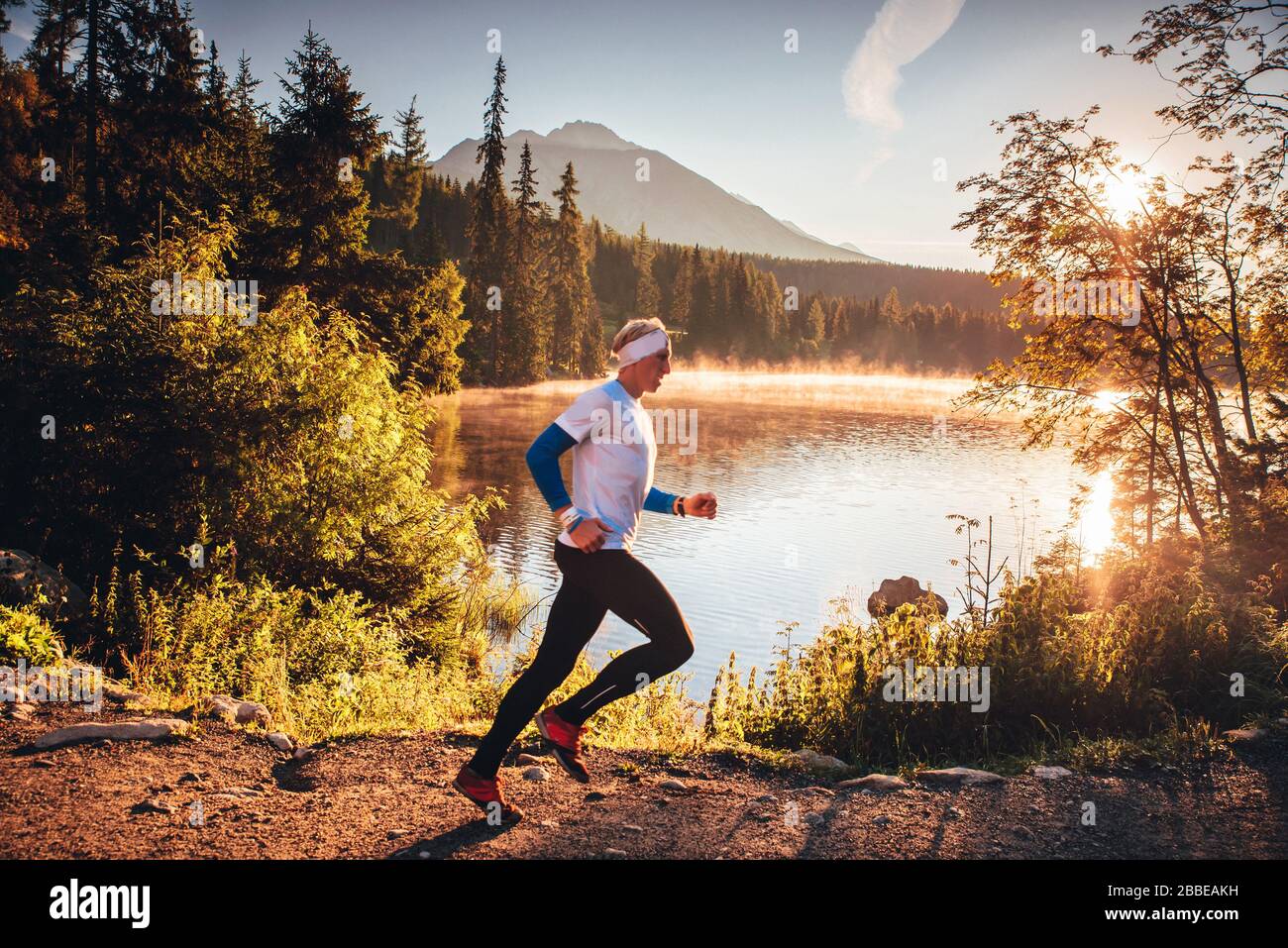 Alone trail runner in orange morning nature in mountains Stock Photo ...