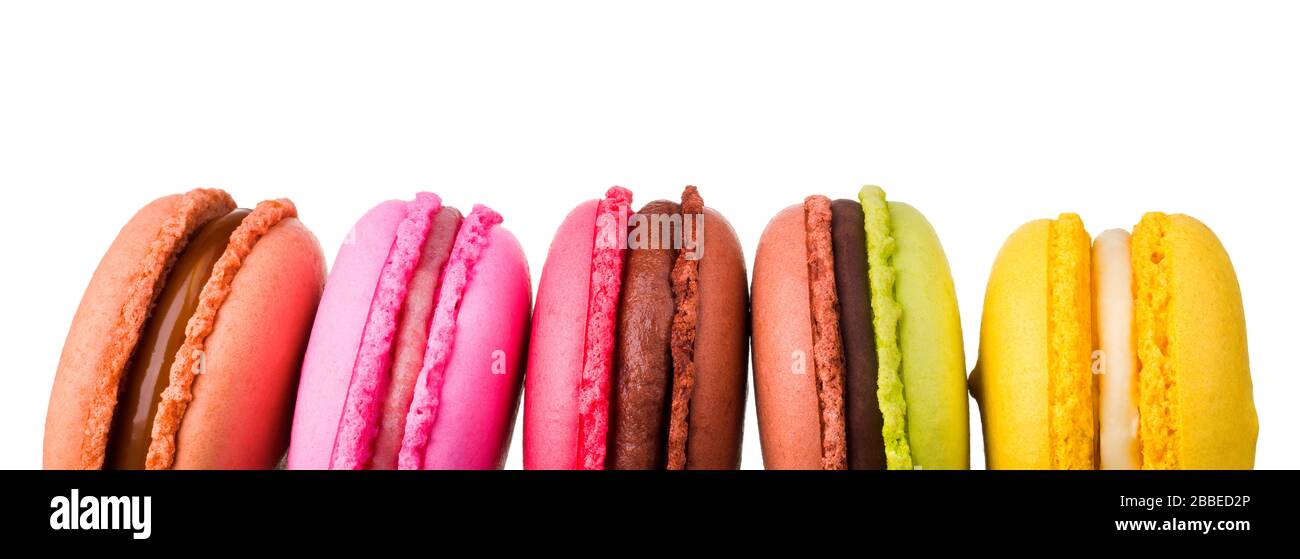 Stack of french colorful macaroons in row isolated on white background ...