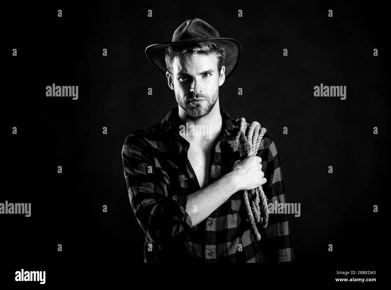 farmer culture. man checkered shirt on ranch. cowboy with lasso rope ...