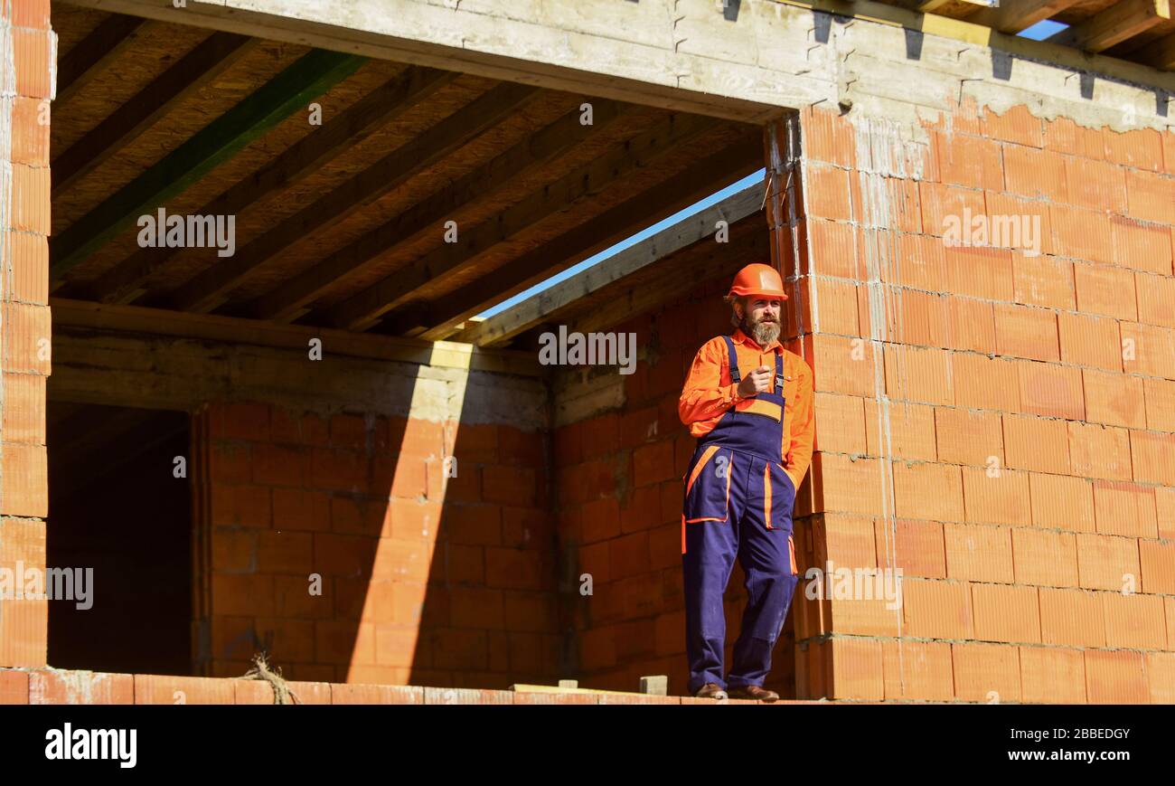 Well done. Repairman tired builder relaxing at construction site ...