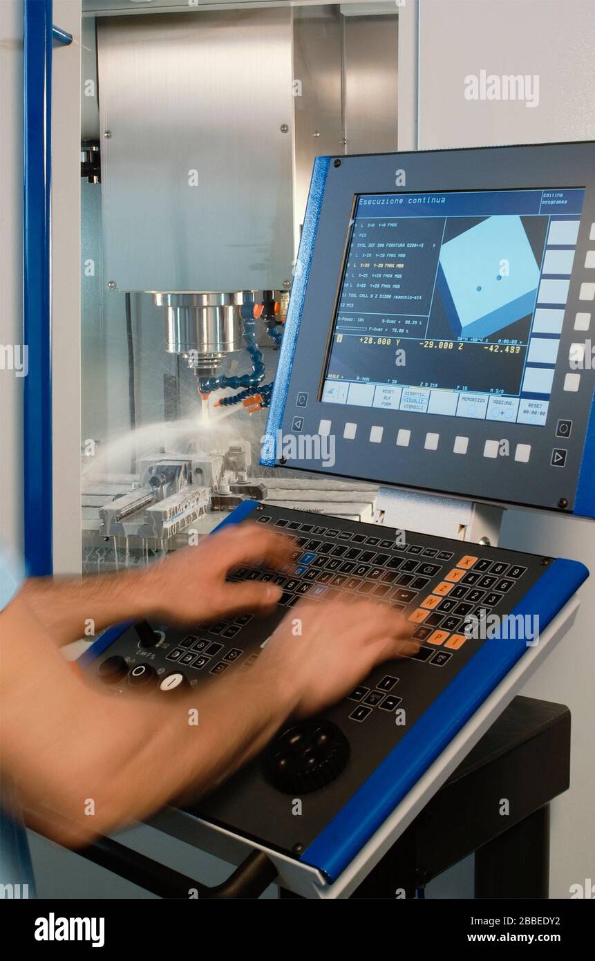 Technician working with a milling machine Stock Photo - Alamy