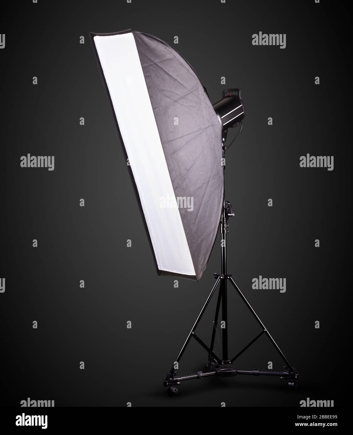 Studio lighting stands with flash and softbox isolated on the black ...