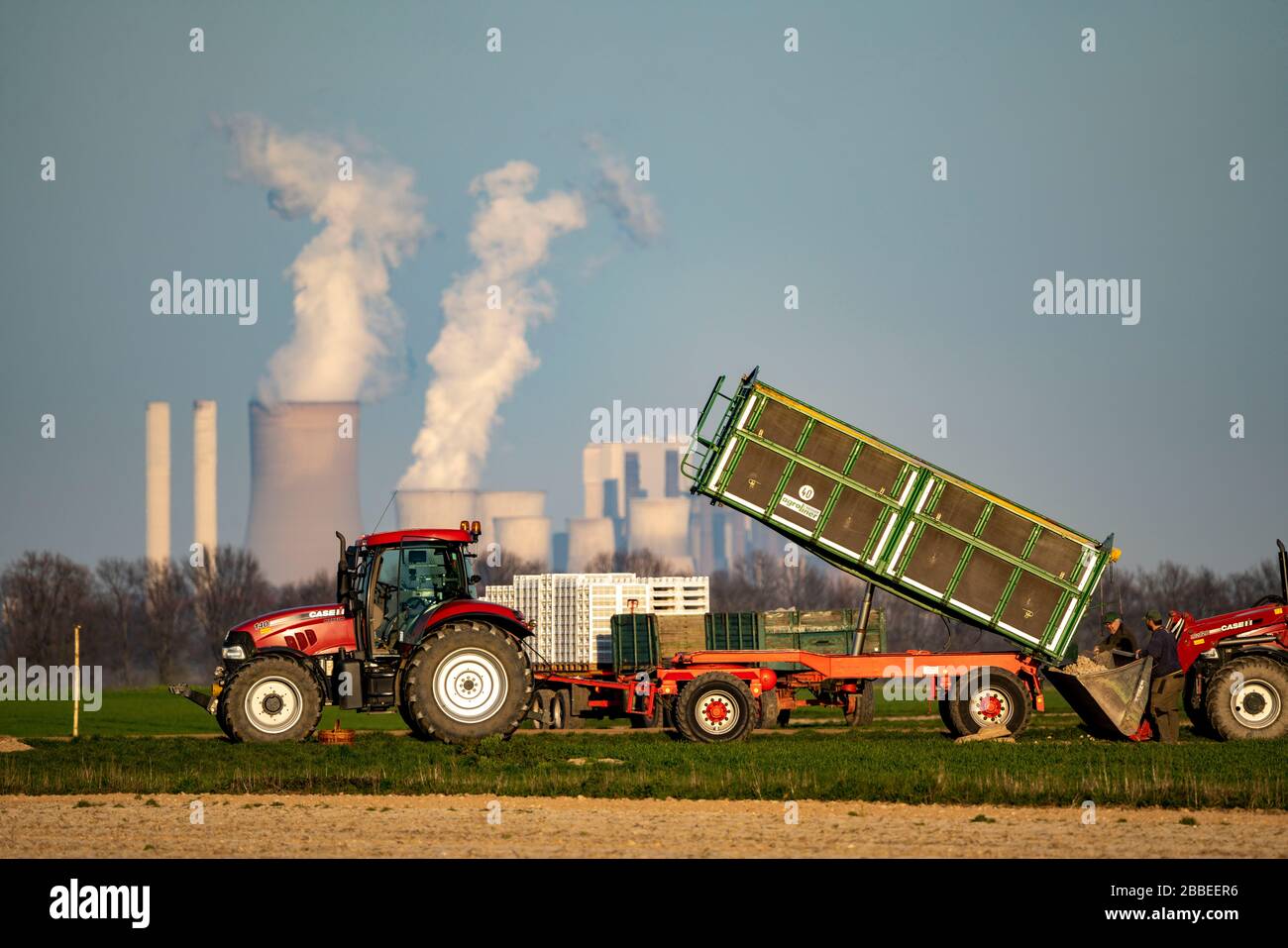 Tractor working a field in spring, potato planting machine, sowing ...