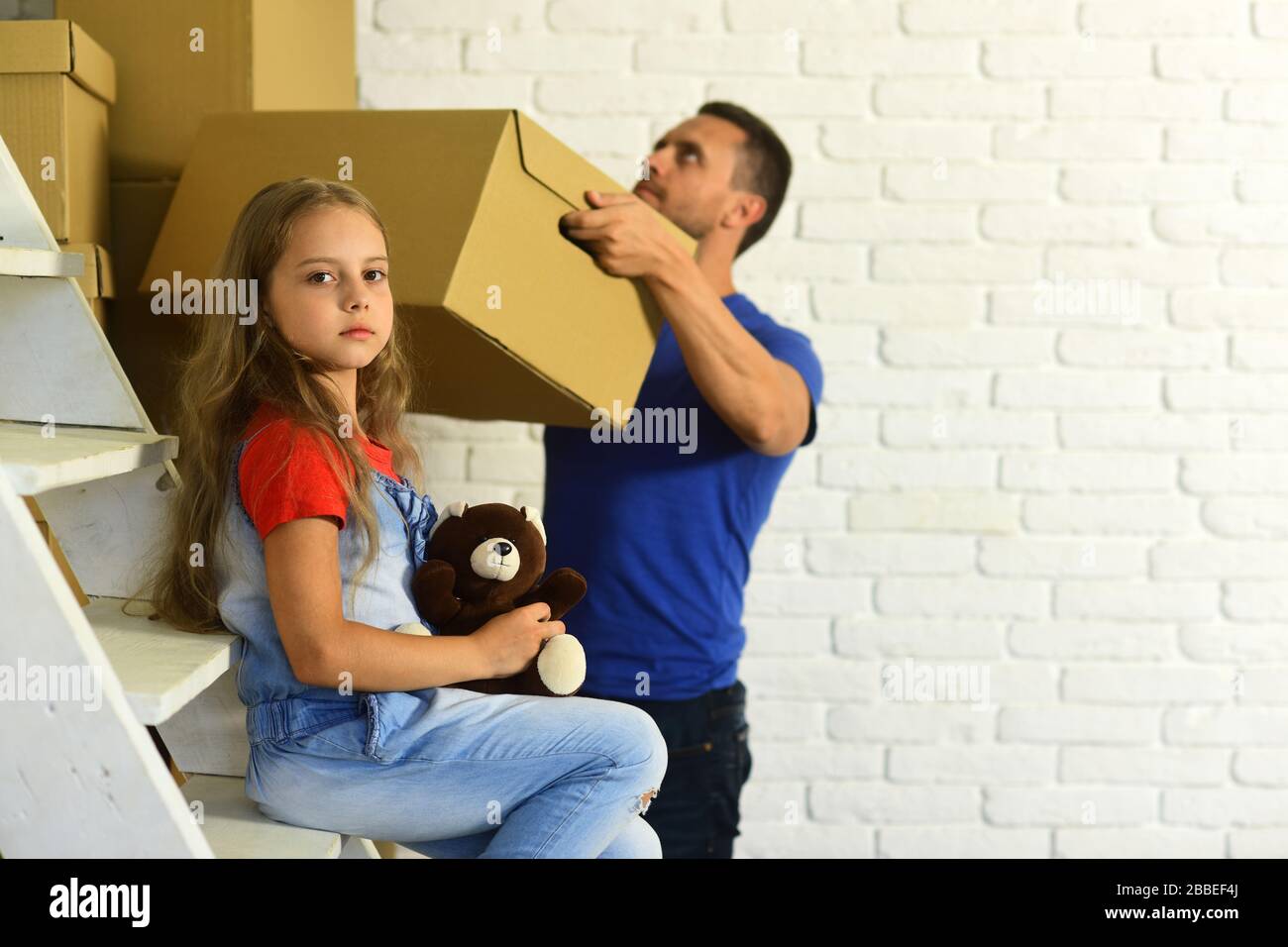 Kid and guy move in or move out. Girl and man with busy and sad faces ...