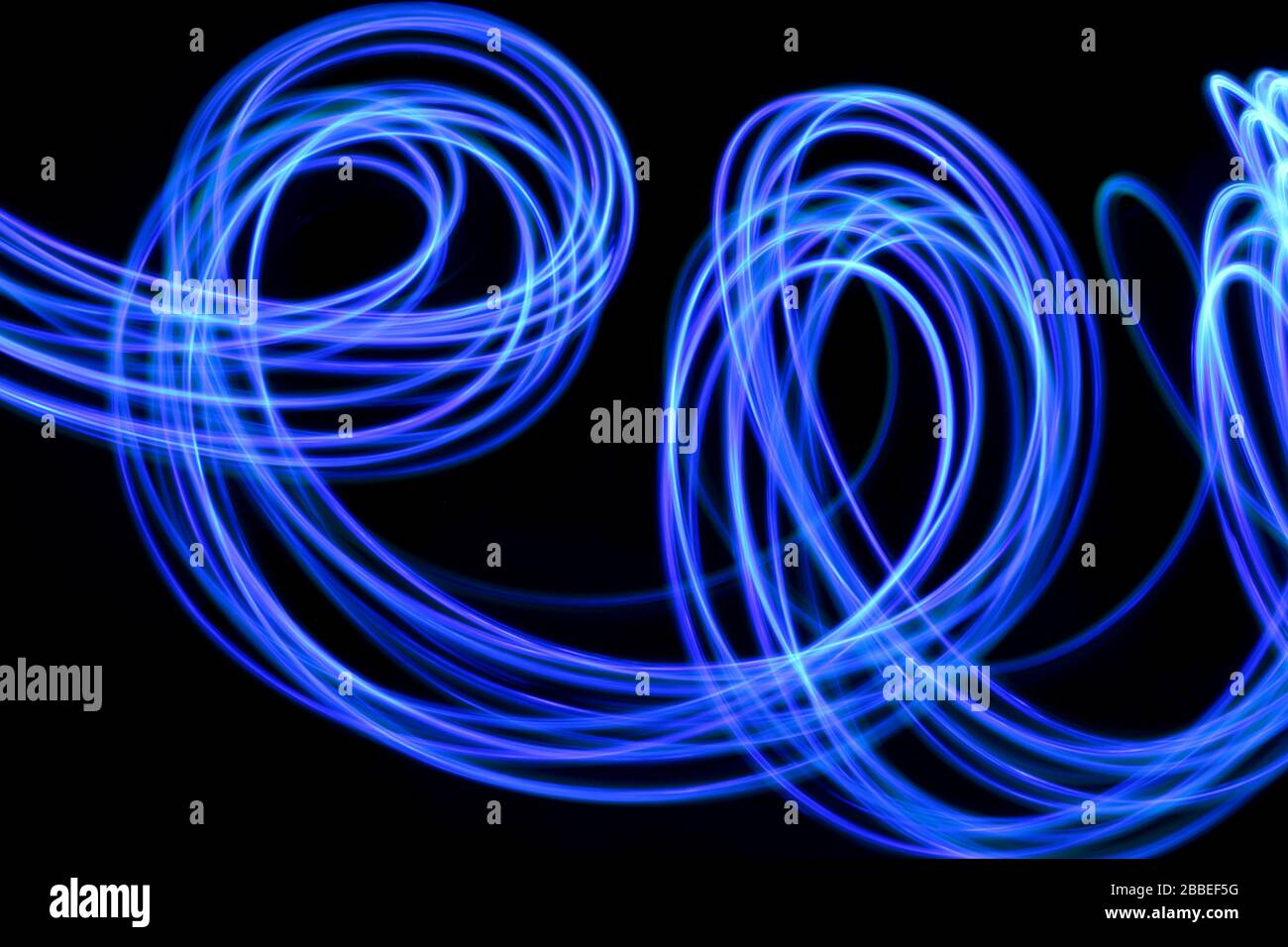 Long exposure photograph of vibrant neon color in an abstract swirl ...