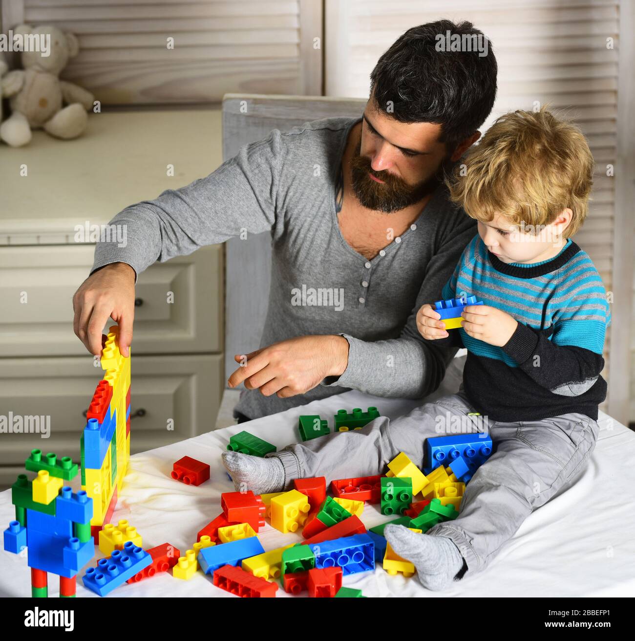 Man and boy play together on wood wall background. Family and childhood ...