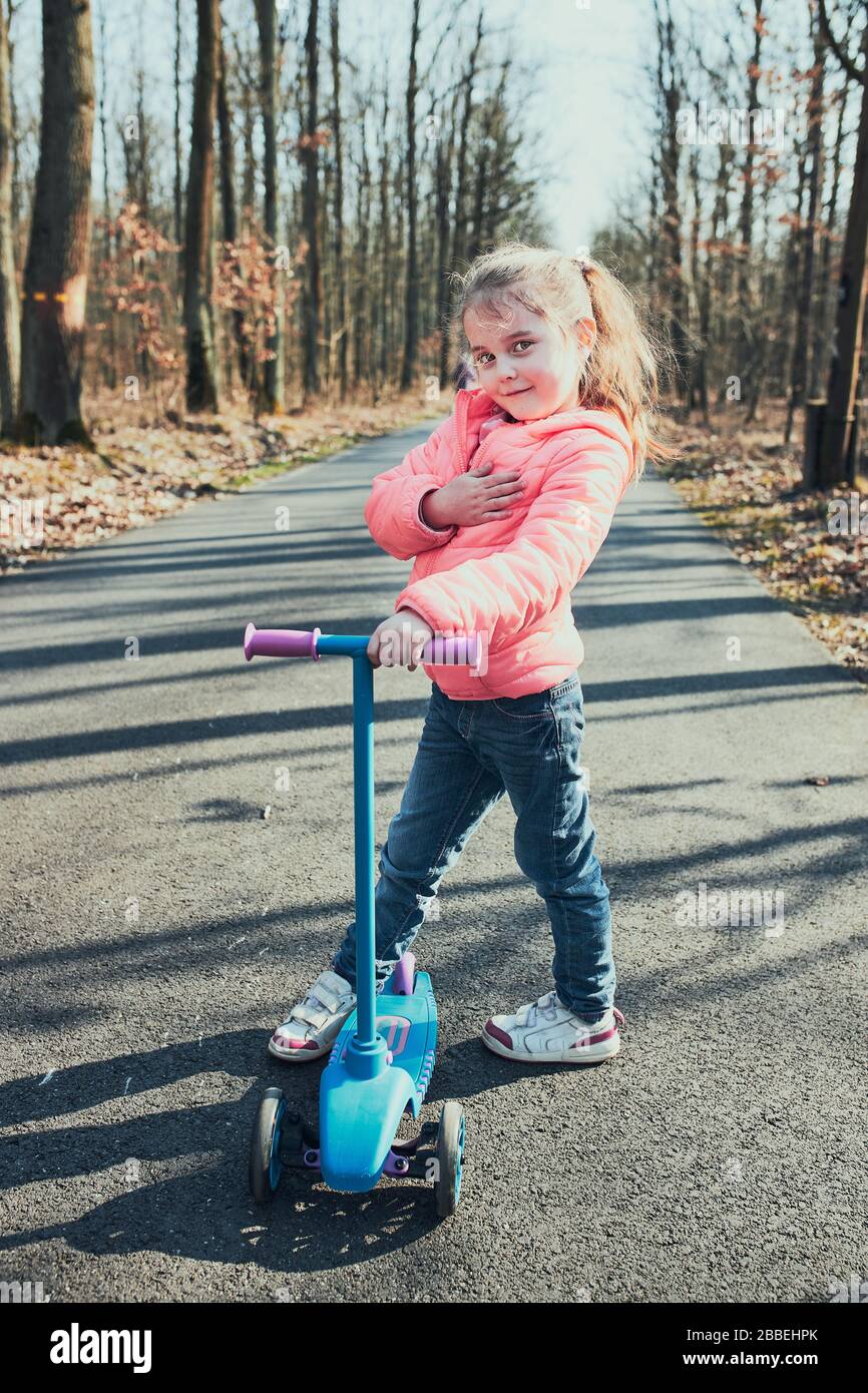 Child playing in road with scooter hi-res stock photography and images ...