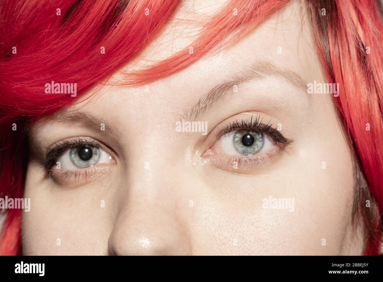 Attented. Close up of face of beautiful caucasian young woman, focus on ...