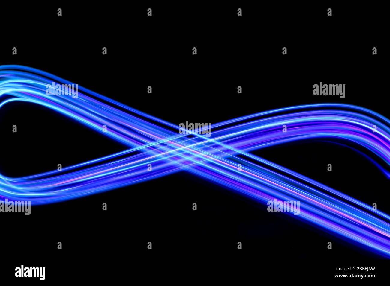 Long exposure photograph of vibrant neon color in an abstract swirl ...