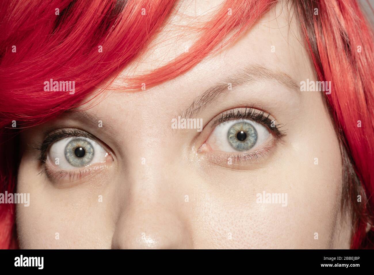 Shocked. Close up of face of beautiful caucasian young woman, focus on ...