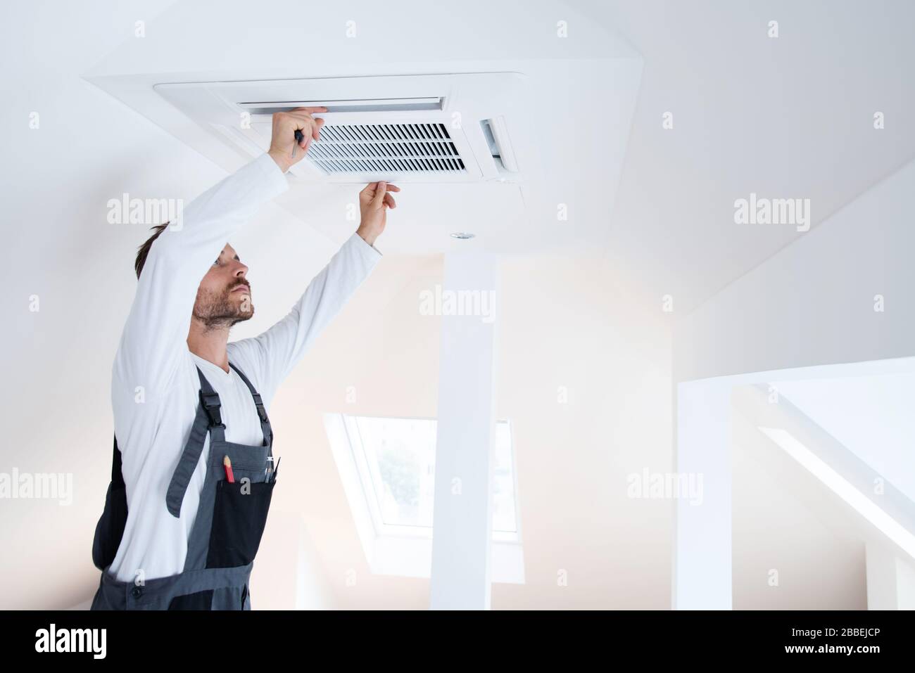 Air conditioning technician works on an air conditioner Stock Photo - Alamy