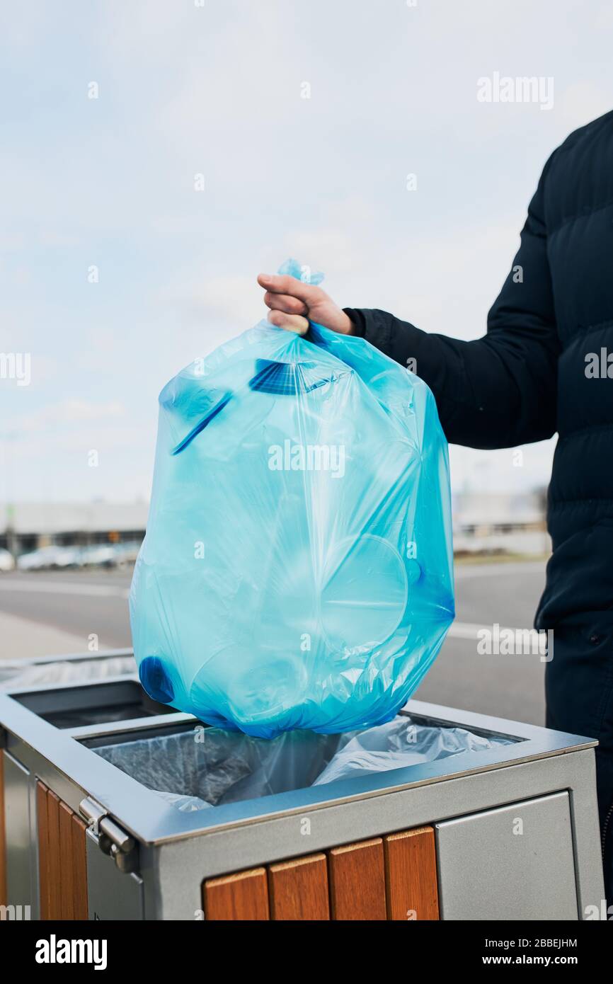 Man throwing a bag full of plastic waste to trash. Plastic waste to ...