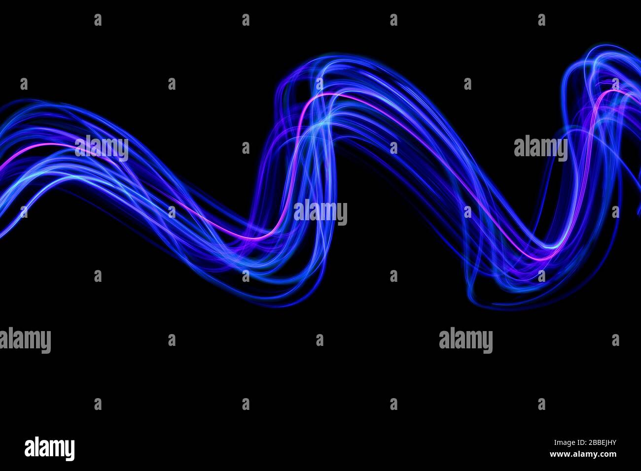 Long exposure photograph of vibrant neon color in an abstract swirl ...