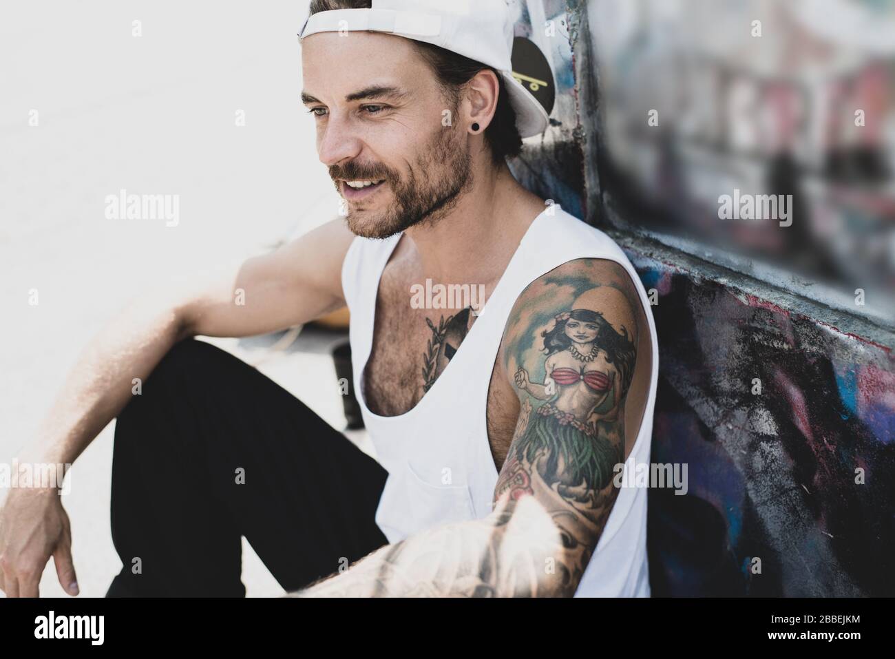 Cool guy with tattoos and baseball cap Stock Photo - Alamy