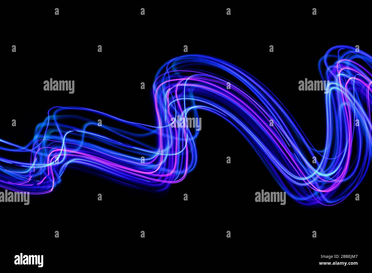 Long exposure photograph of vibrant neon color in an abstract swirl ...