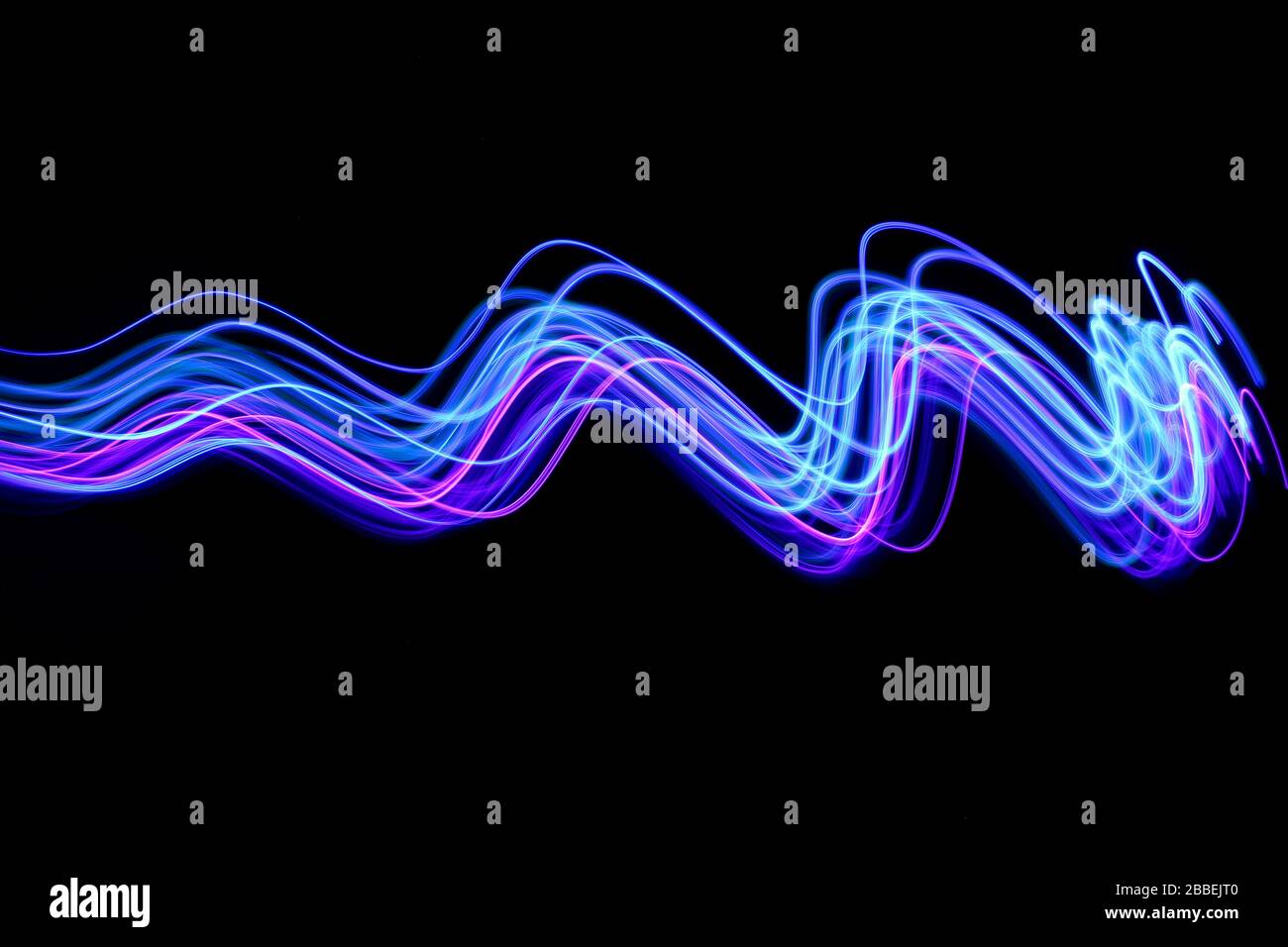 Long exposure photograph of vibrant neon color in an abstract swirl ...