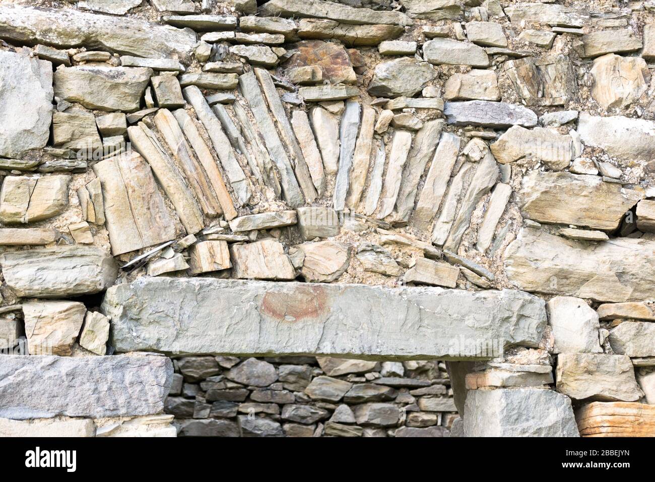 An old dry stone wall with an arch in it Stock Photo - Alamy