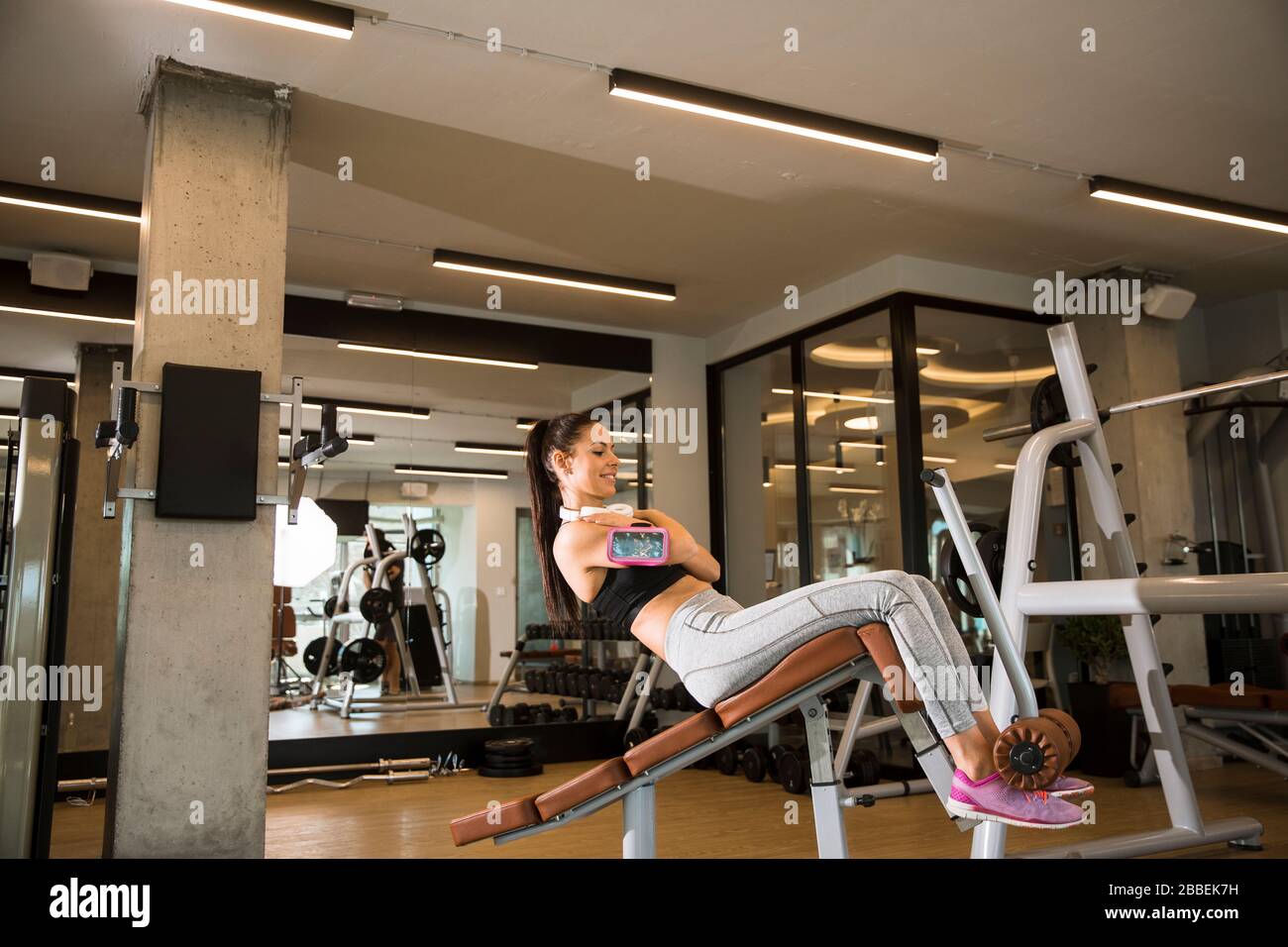 Pretty young woman have a training at sit up bench in the gym Stock ...