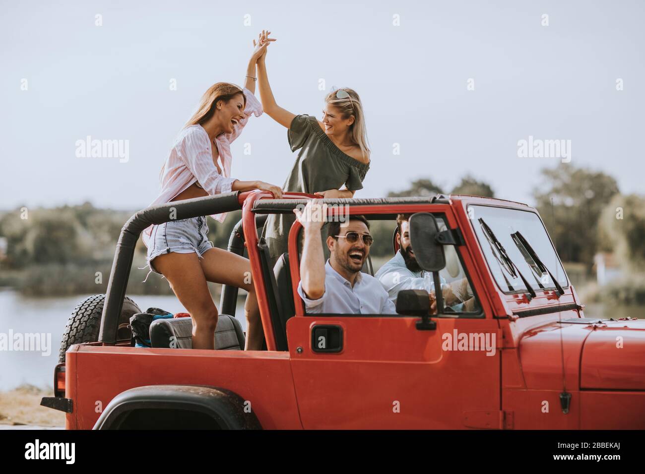 Group of happy young people enjoying road trip Stock Photo - Alamy