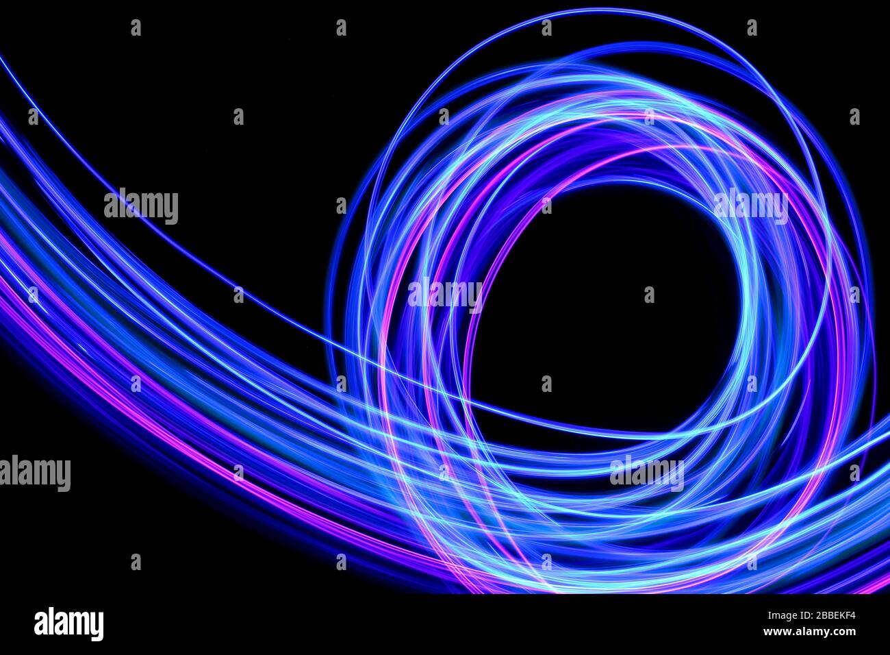 Long exposure photograph of vibrant neon color in an abstract swirl ...