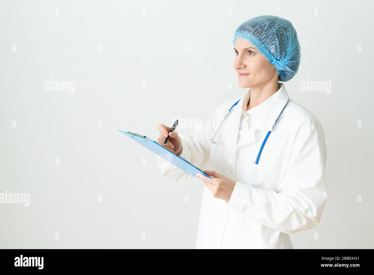 Female adult doctor stands on white background. Beautiful woman ...