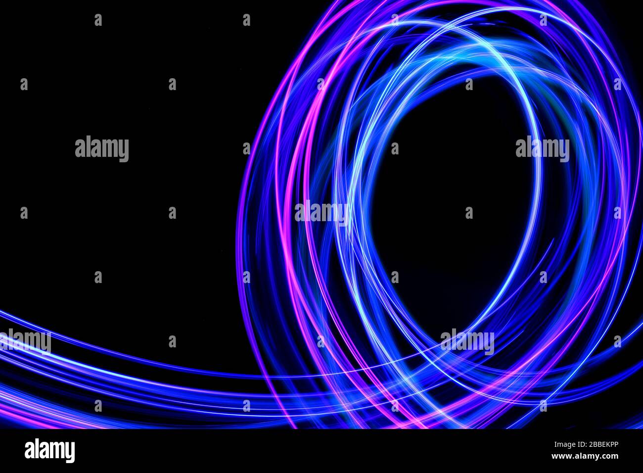 Long exposure photograph of vibrant neon color in an abstract swirl ...