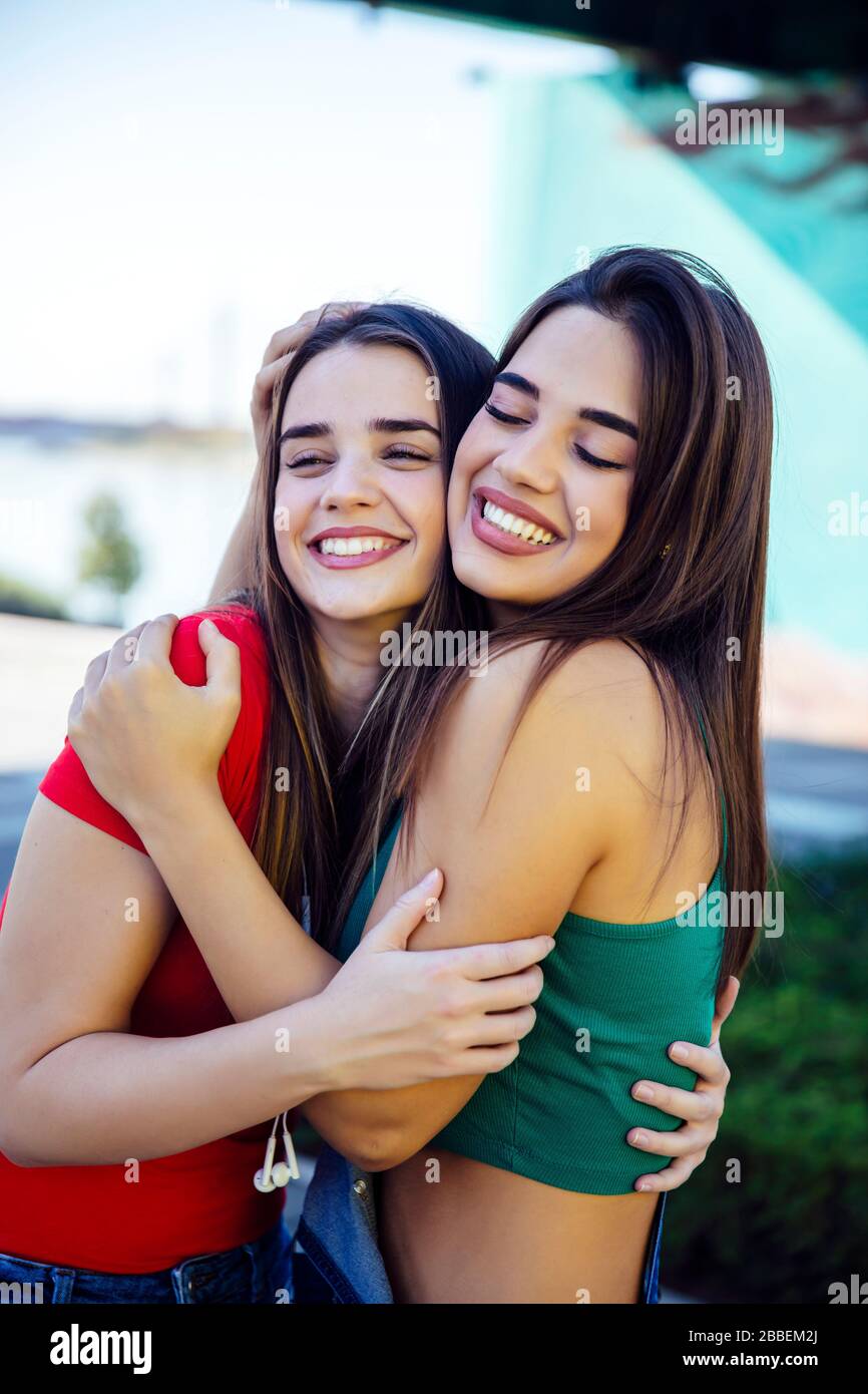 Two best female friends embracing together outdoors Stock Photo - Alamy