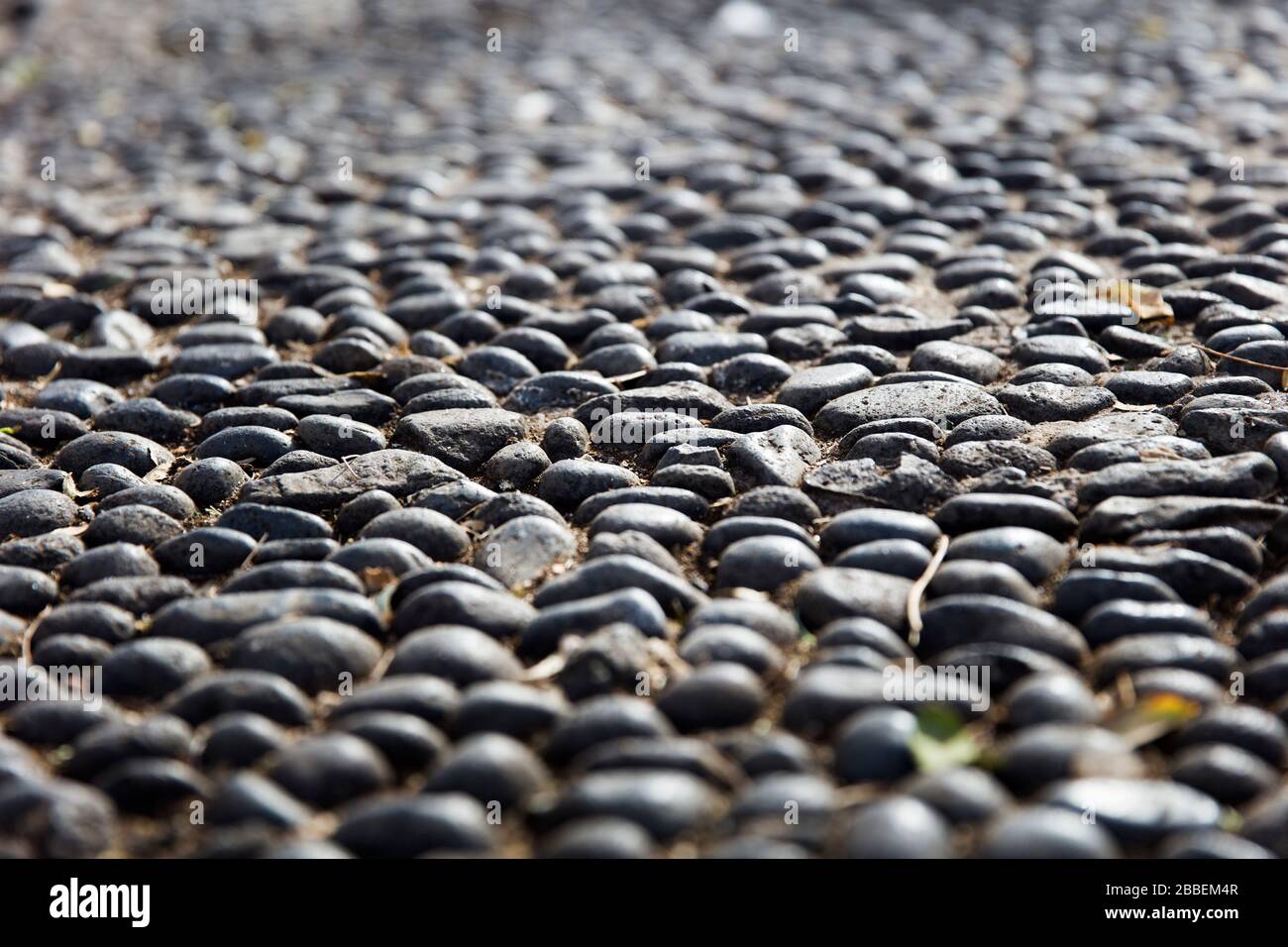 Closeup detail of the pebbles stone road backdrop Stock Photo - Alamy