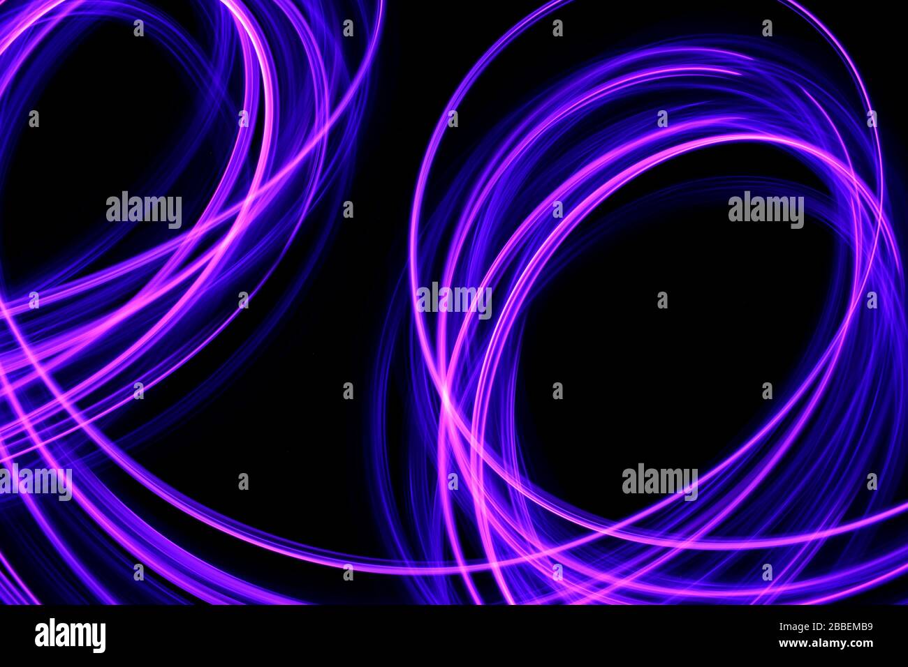 Long exposure photograph of vibrant neon color in an abstract swirl ...