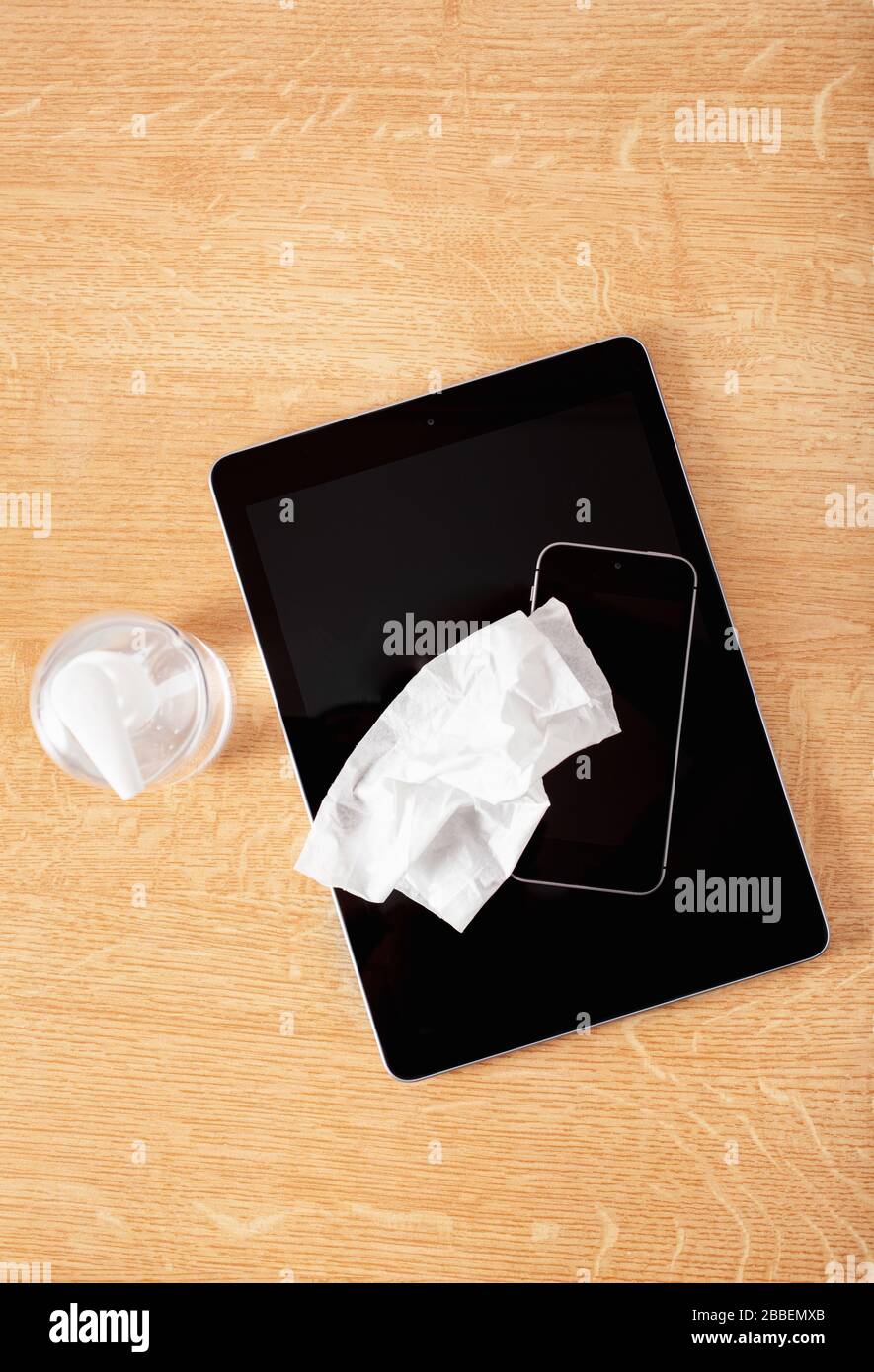 disinfecting tablet computer and smartphone screen, eliminating germs ...