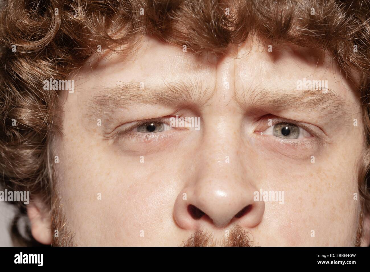 Serious, uncertain. Close up of face of beautiful caucasian young man ...