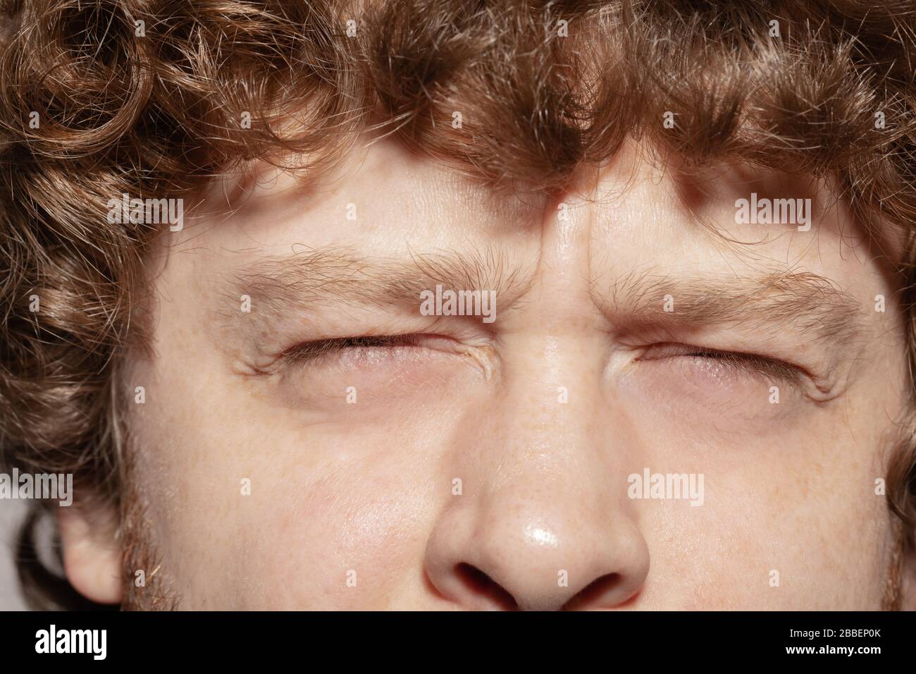 Tryna to look. Close up of face of beautiful caucasian young man, focus ...